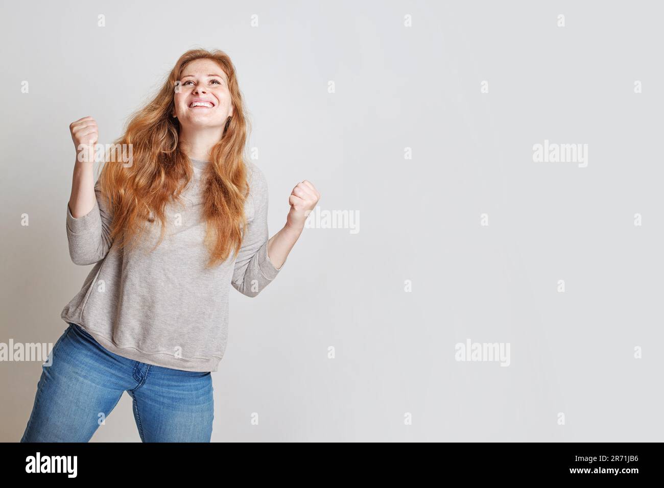 Beautiful happy woman with positive facial expression standing against ...