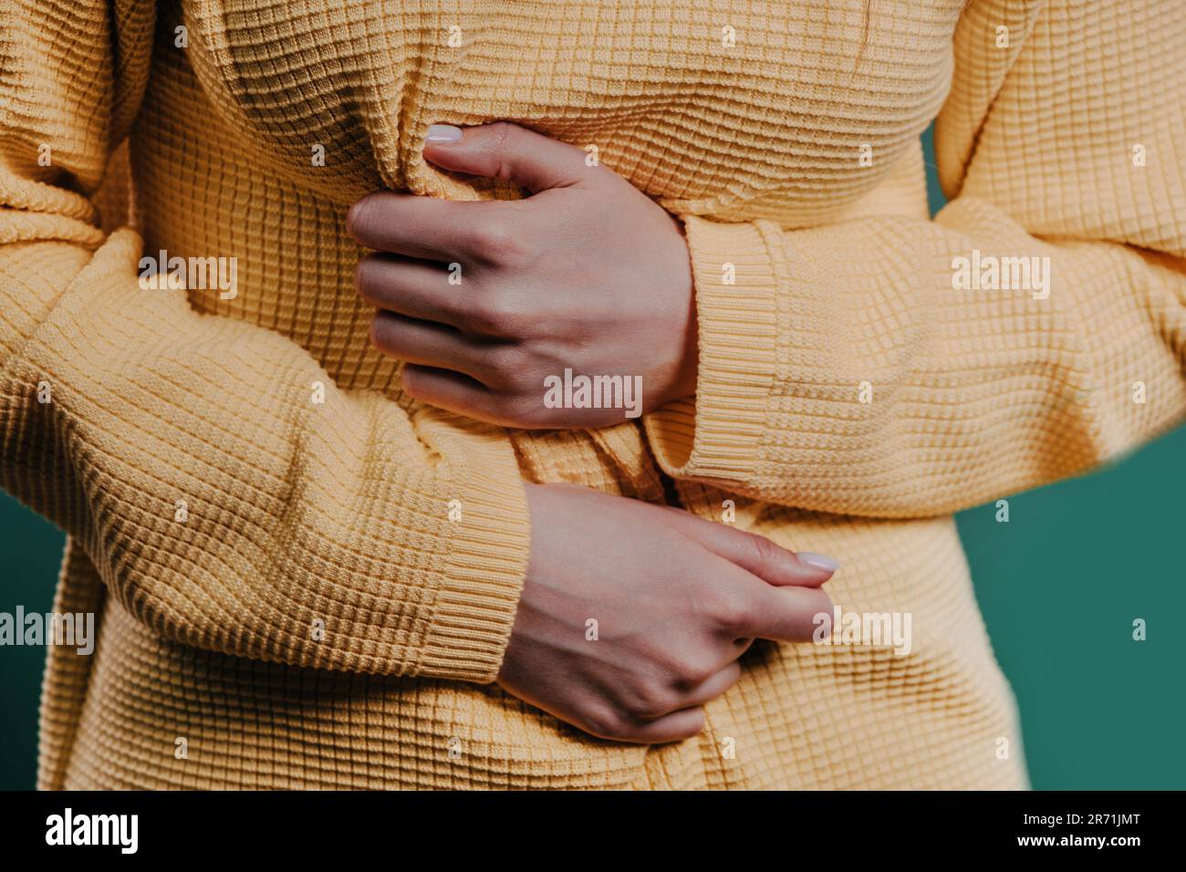 Woman squeezing belly hands because of abdominal pain. Suffering ...