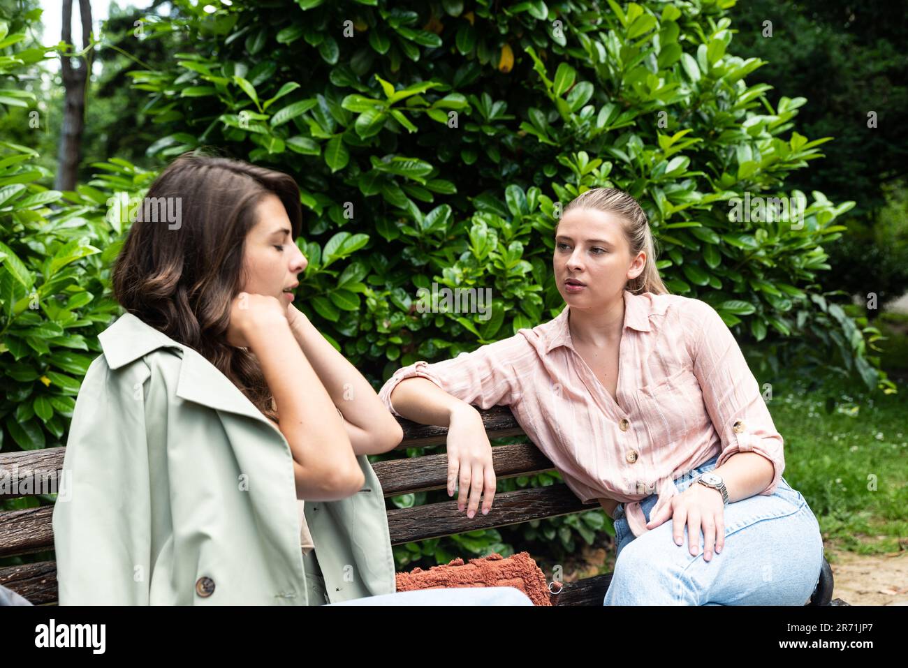 Friend comforting a stressed friend. Two woman young females talking in ...