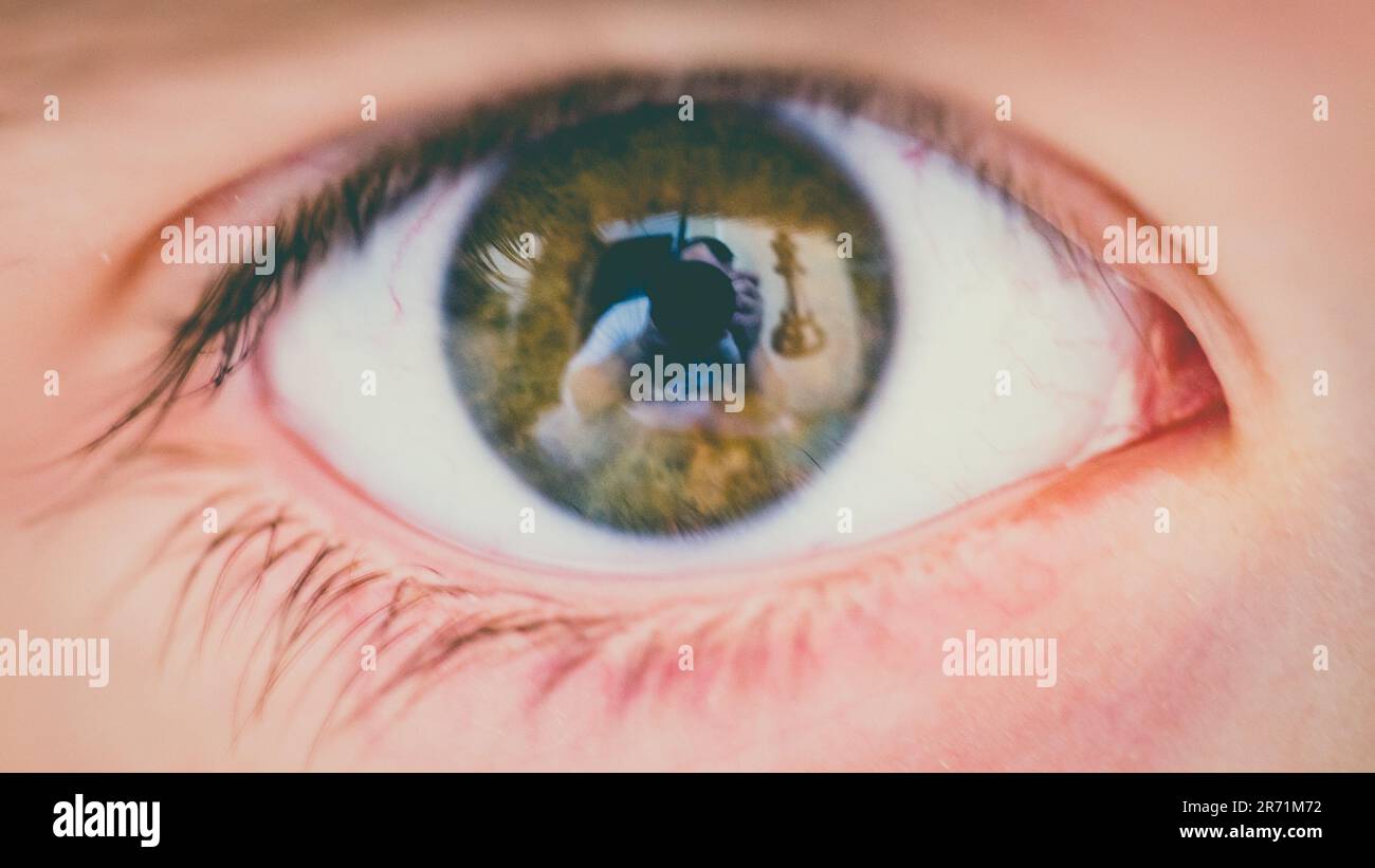 An eye with a reflection of a photographer taking a picture Stock Photo ...