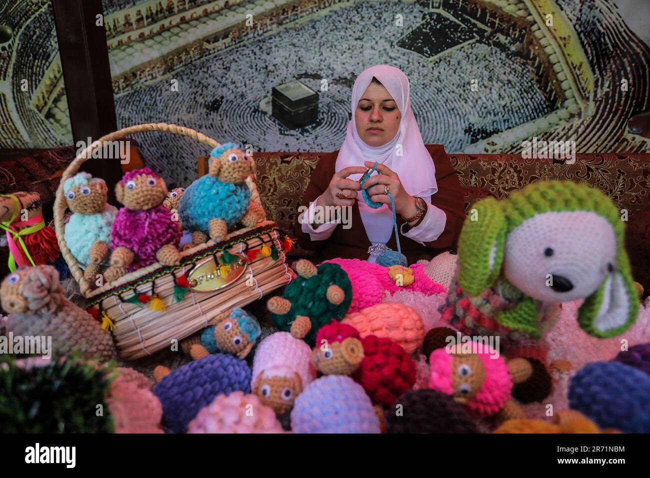 A Palestinian woman, Reham Shurrab, works on weaving sheep dolls in ...