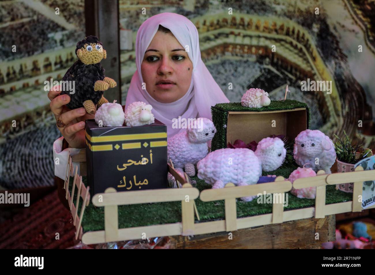 A Palestinian woman, Reham Shurrab, works on weaving sheep dolls in preparation for the blessed ...