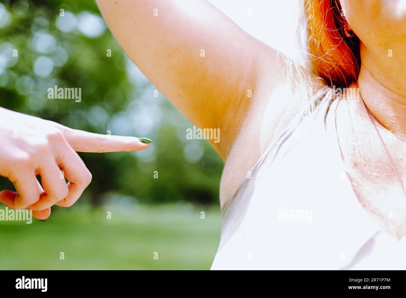 Sweaty armpit woman with wet spot on clothes Stock Photo - Alamy
