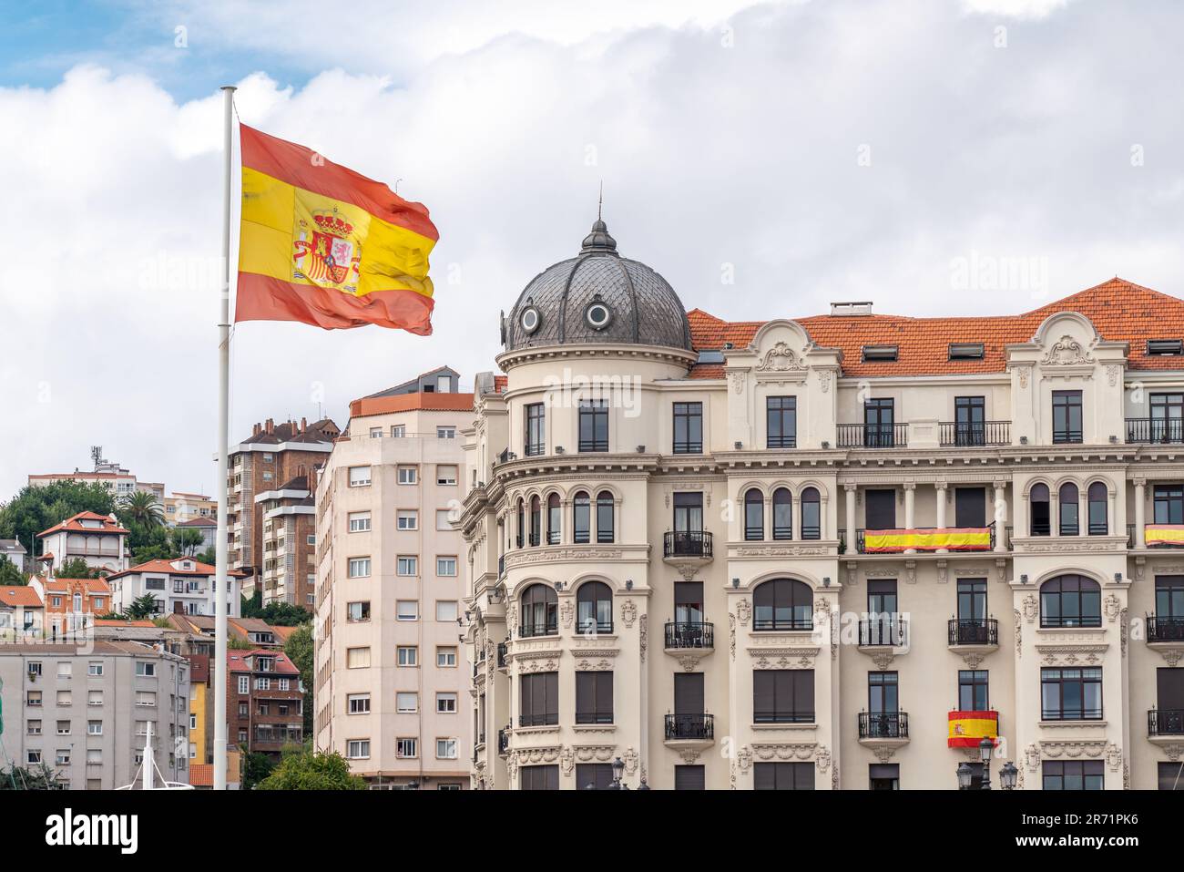 Spanish flag in the Port of Santander. In background beautiful building ...