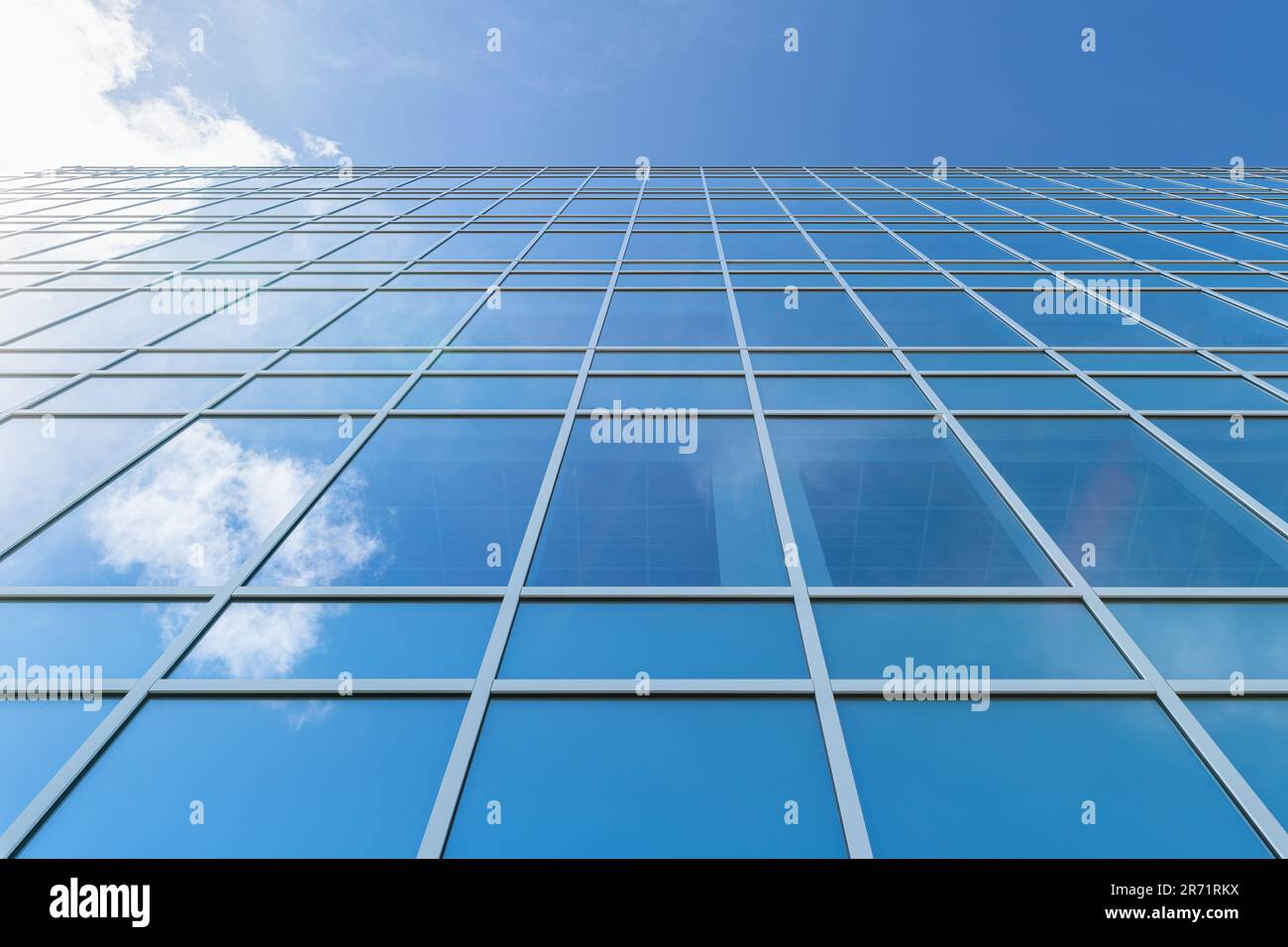 A low angle photograph of the side of a tall building made from glass ...