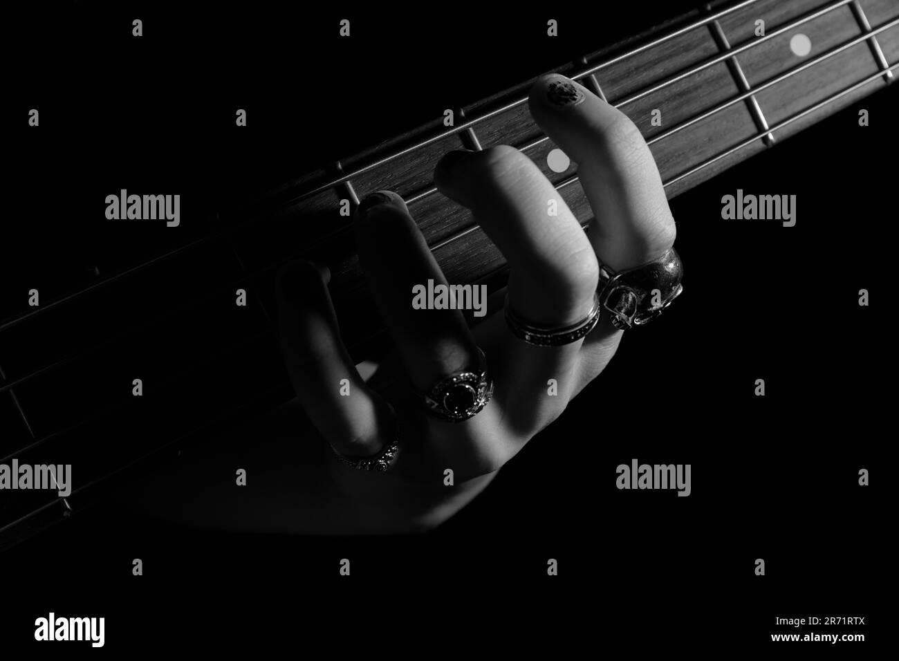 Rocker with his classic electric bass guitar Stock Photo - Alamy