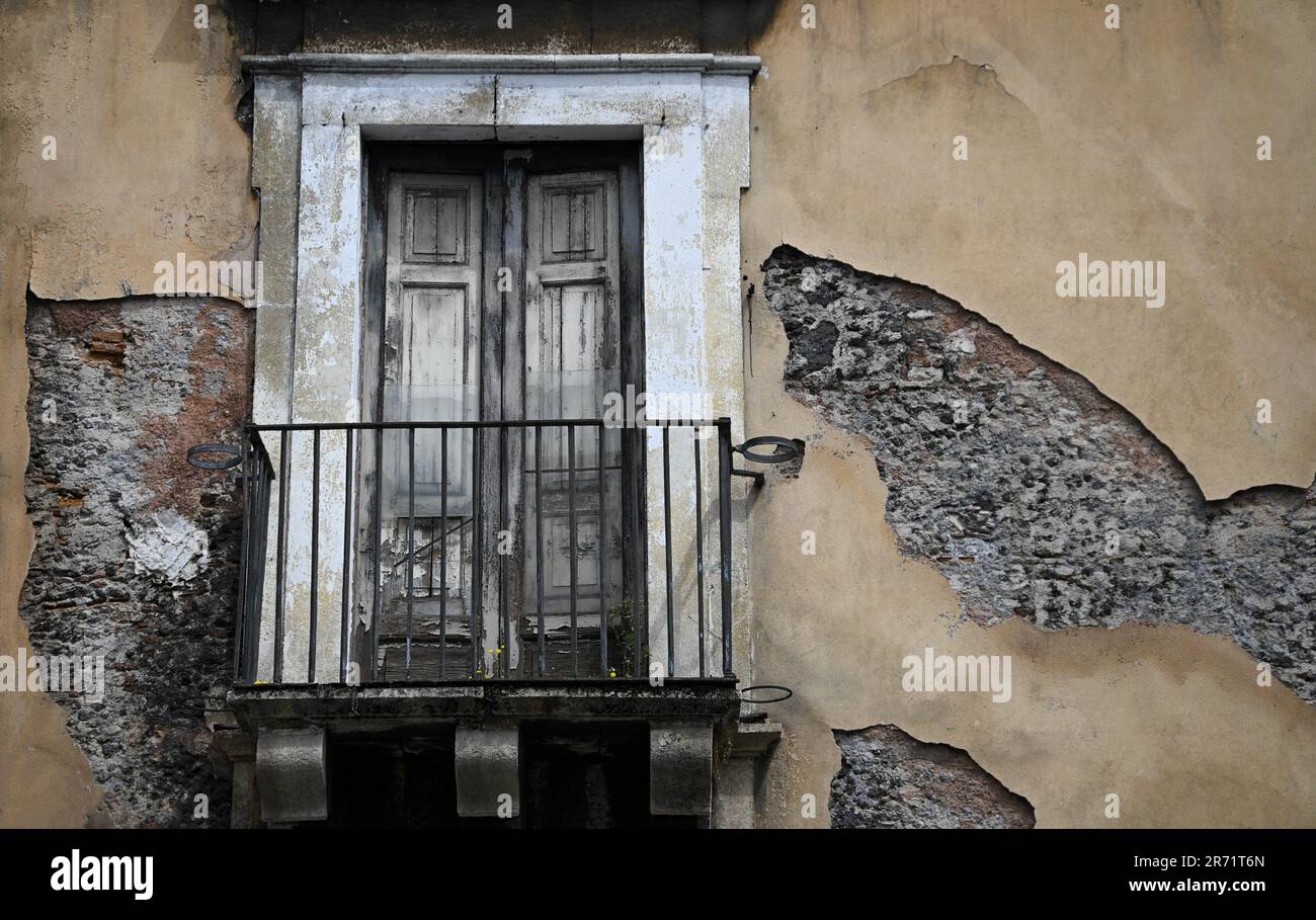 Old Neoclassical building window with a limestone trim, a weathered ...