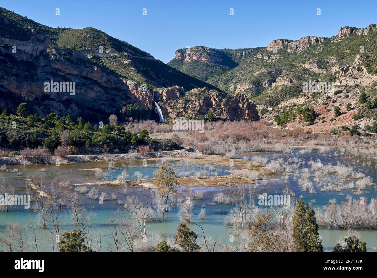 A majestic landscape featuring a vast lake situated close to a towering ...
