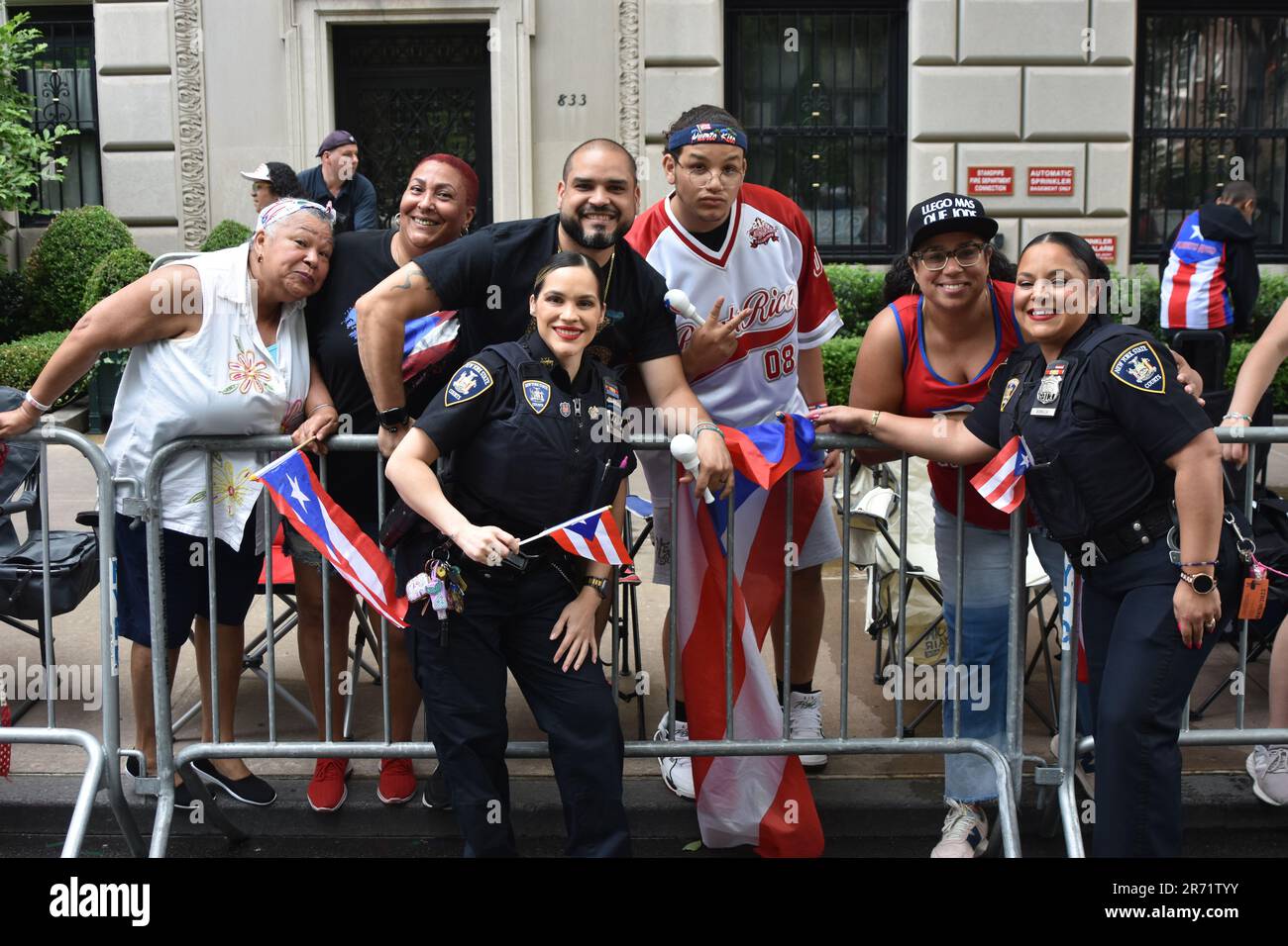 NYC police posing with revelers on the parade route Stock Photo - Alamy