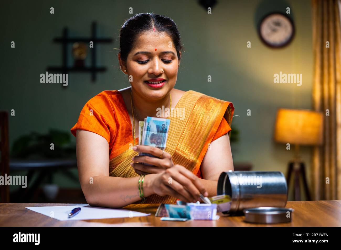 Indian woman counting money hi-res stock photography and images - Alamy
