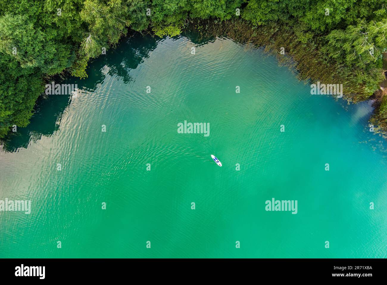 Aerial top down view of beautiful green waters of lake Gela. Birds eye ...