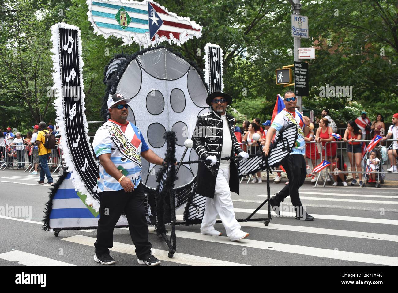 Marcher with musical instrument float Stock Photo - Alamy