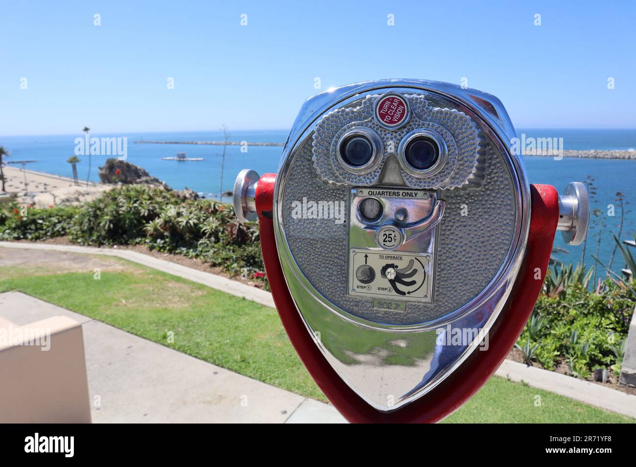 A vintage-style coin-operated telescope located in a scenic coastal ...