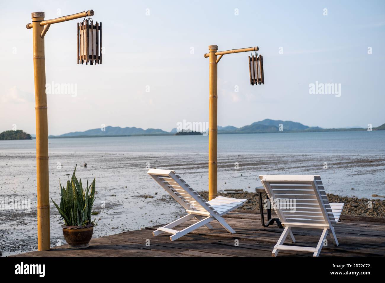 Outdoor seating on the terrace, with bamboo lamp post. With view of the ...