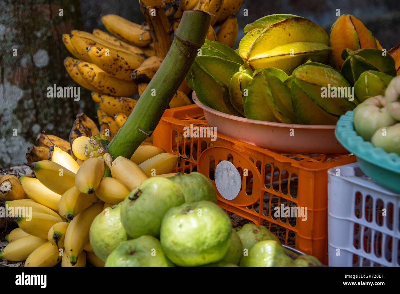 local Balinese fruits like small bananas and star fruit on a market ...