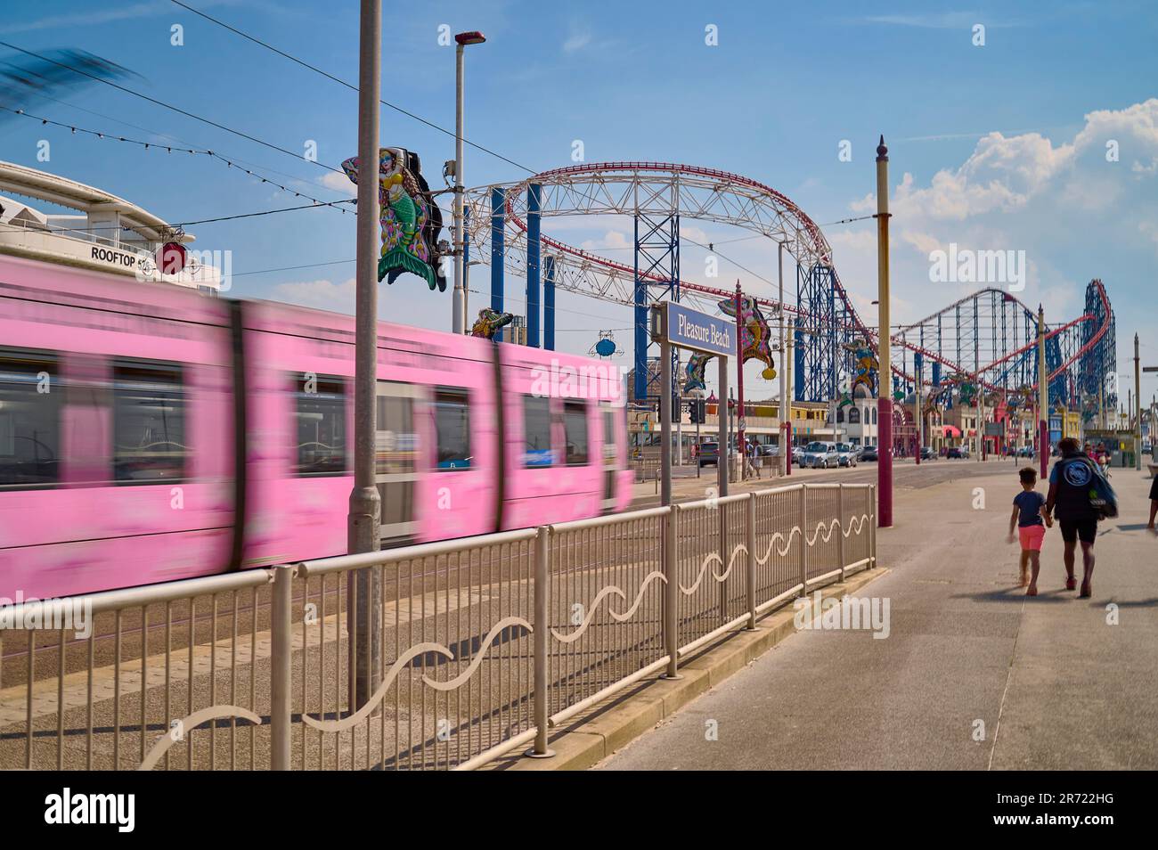 Pink tram passing the Pleasure Beach tram stop with the Big One roller ...