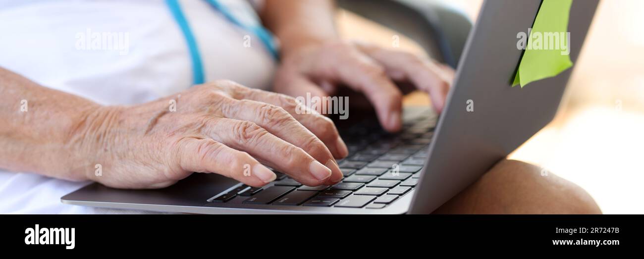 Old woman hands typing on modern laptop Stock Photo - Alamy
