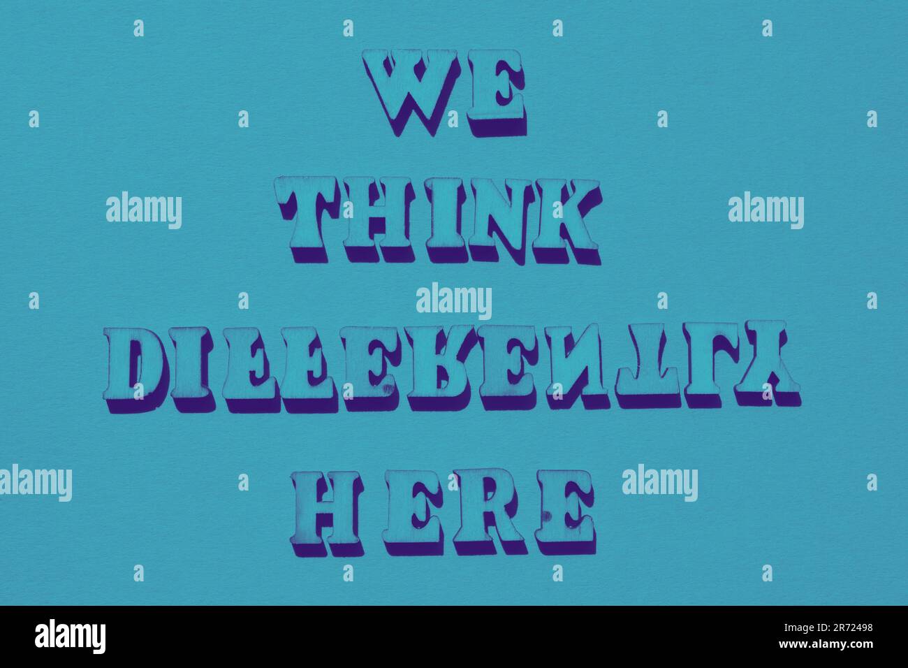 We Think Differently Here, words isolated on blue background Stock ...