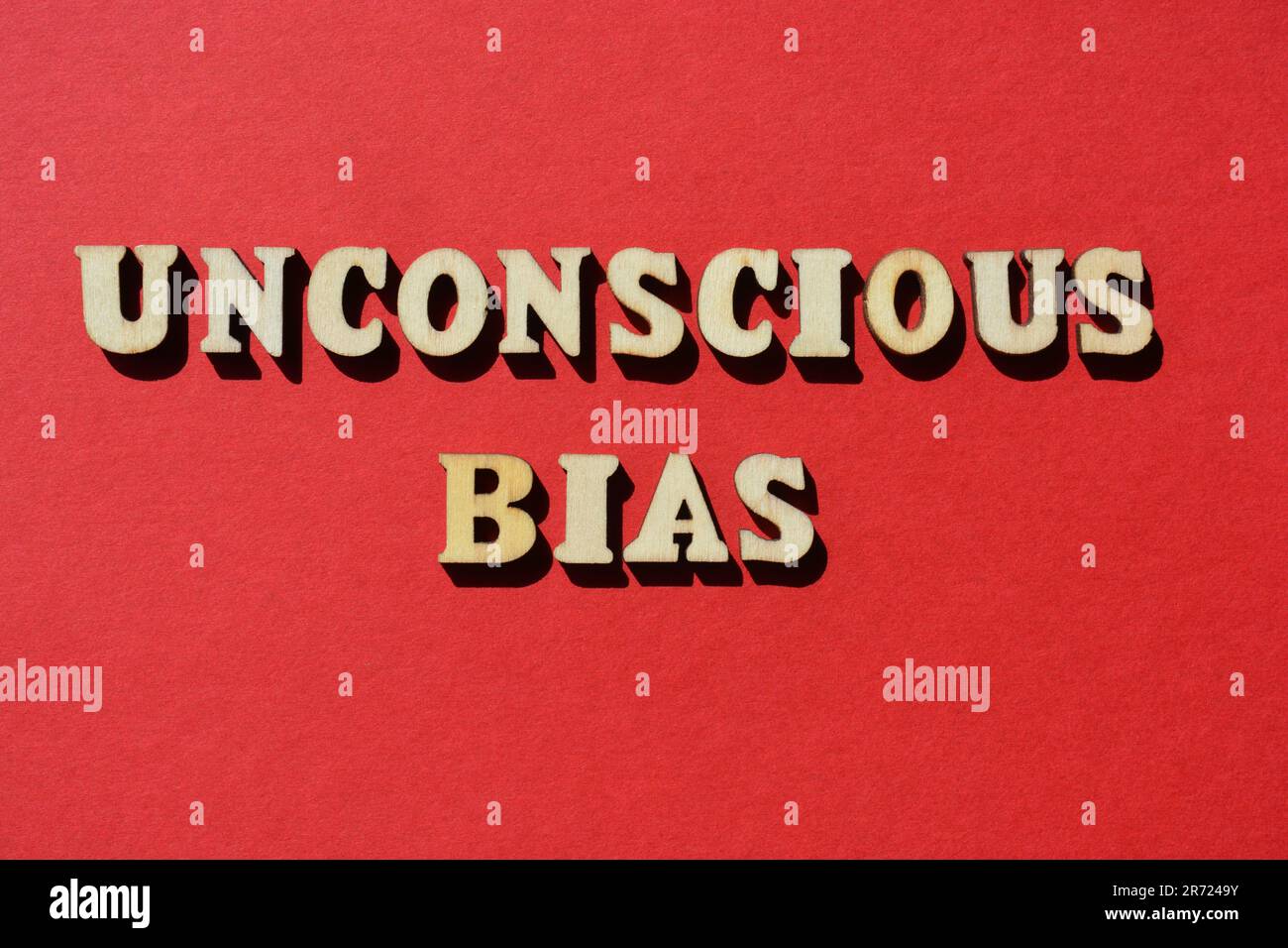 Unconscious Bias, words in wooden alphabet letters isolated on red ...