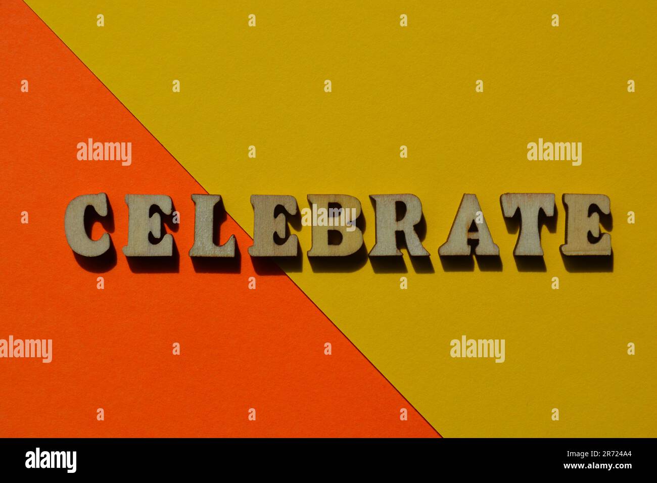 Celebrate, word in wooden alphabet letters isolated on bright yellow ...