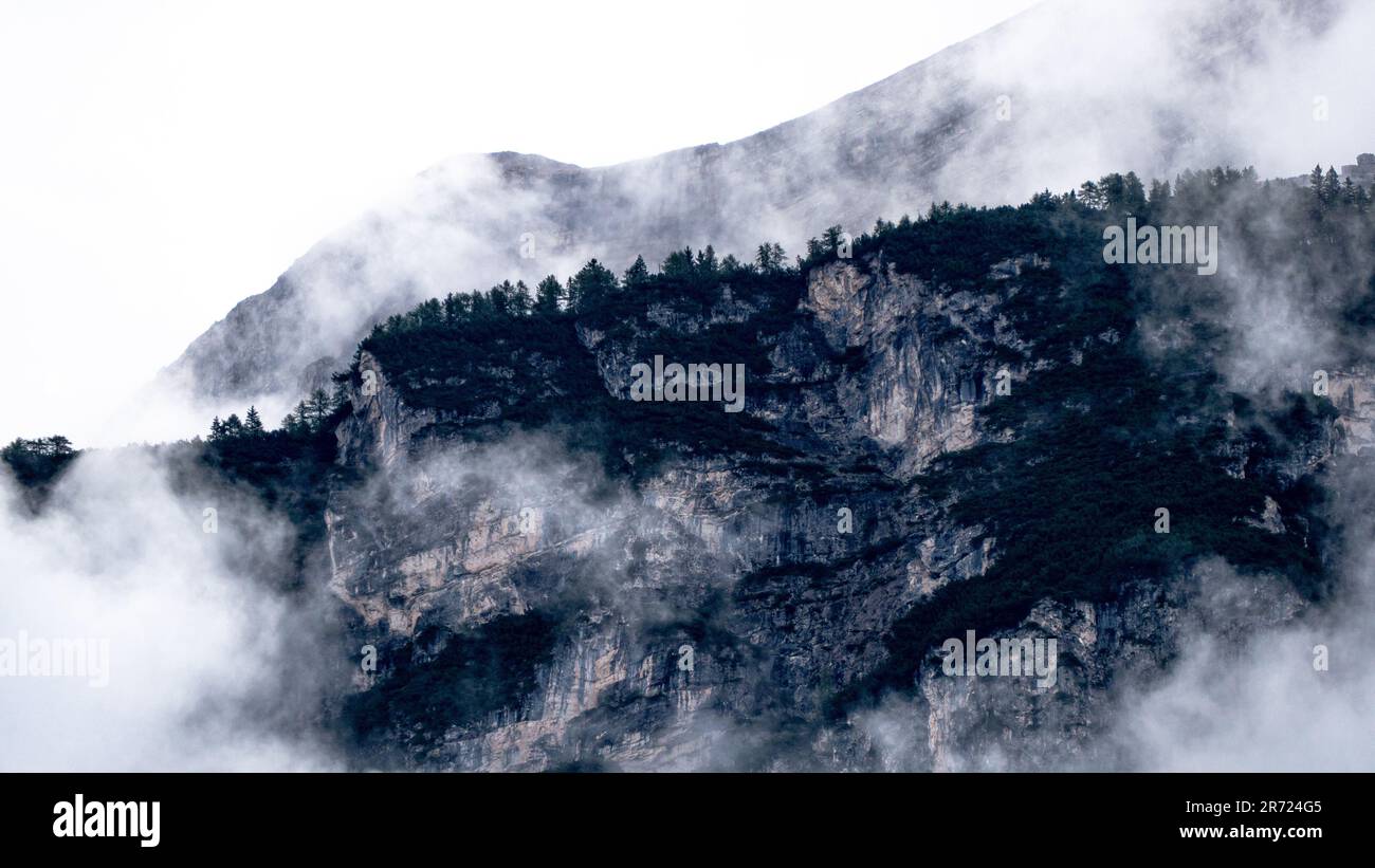Veneto 2022. Parts of mountains, with trees and crevasses, that emerge ...