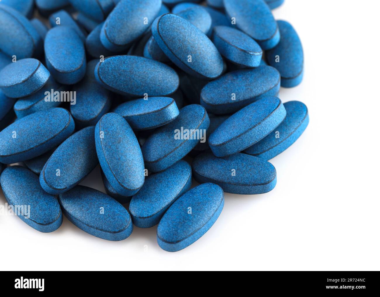 Blue spirulina isolated on white background. Blue oval shaped pills ...
