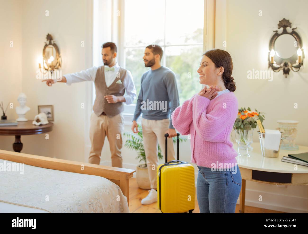 Professional Concierge Introducing Tourists Couple To Suite in Hotel ...