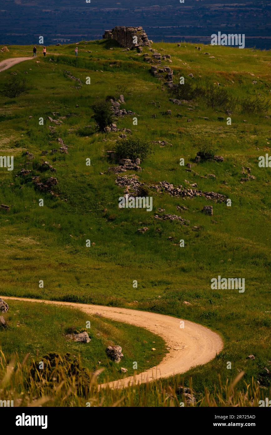 A male mountain biker is riding along a scenic off-road trail with the ...