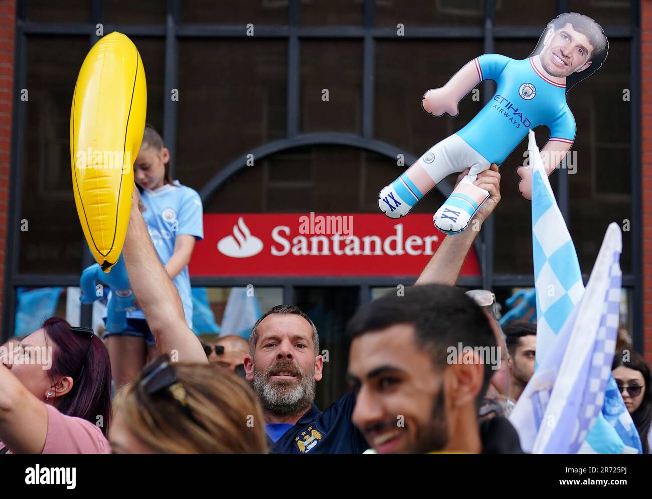 A fan waves an inflatable doll with the face of Manchester City's John ...