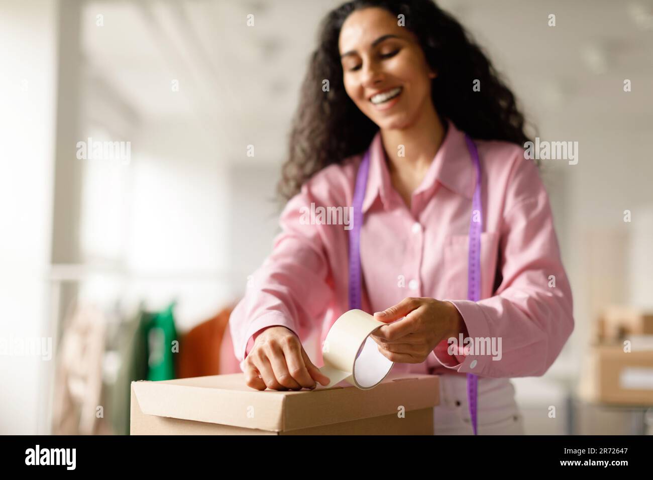 Fashion Stylist Woman Packing Box Standing In Trendy Clothing Showroom ...