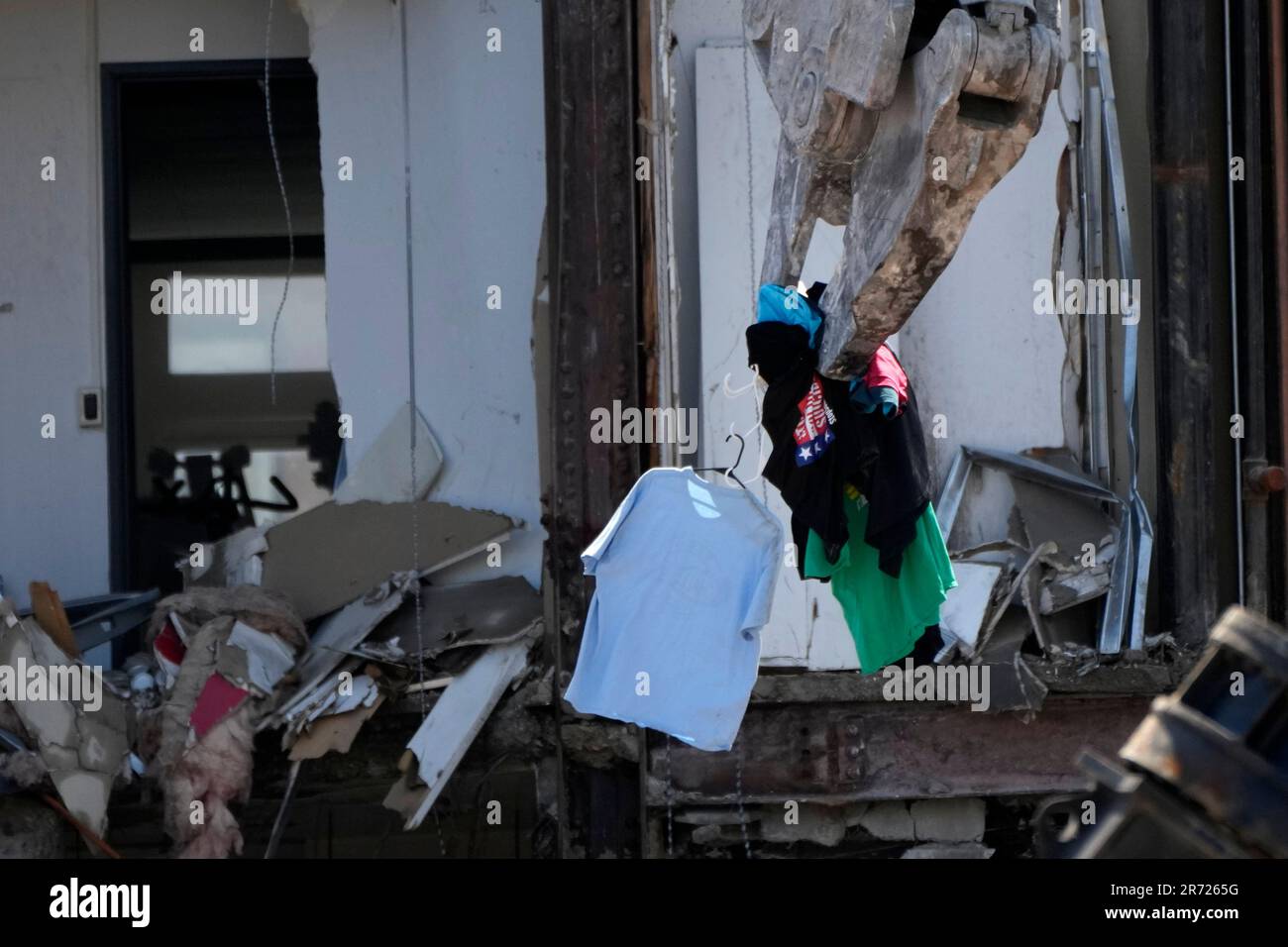 Clothing is removed from a closet during demolition at the site of a ...