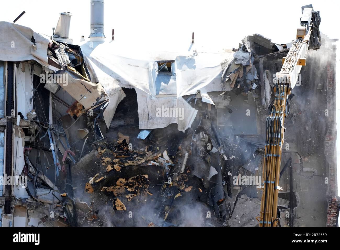 Debris falls as workers begin demolition at the site of a building ...