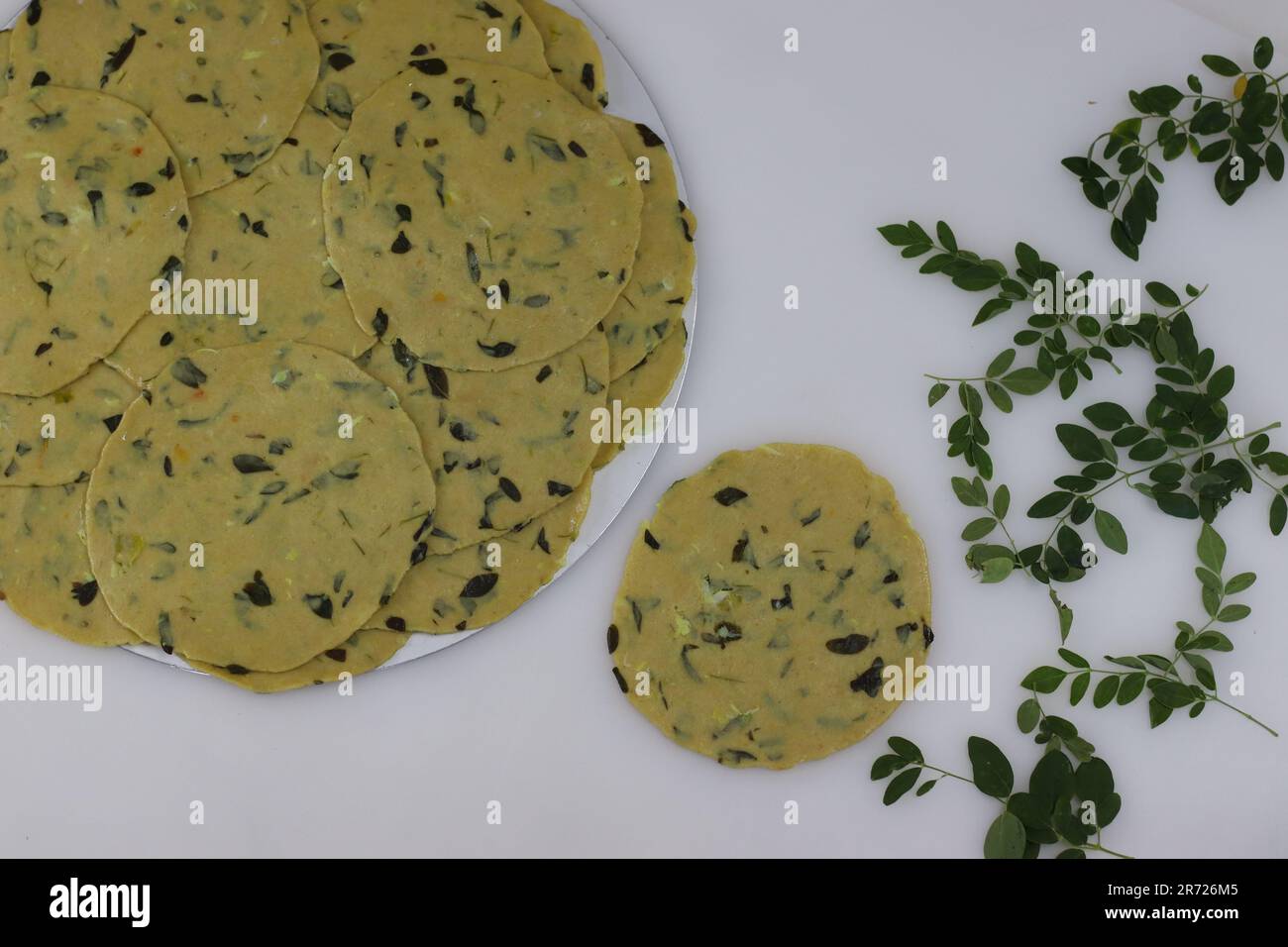 Ready to fry pressed poori made with whole wheat flour, mixed with ...