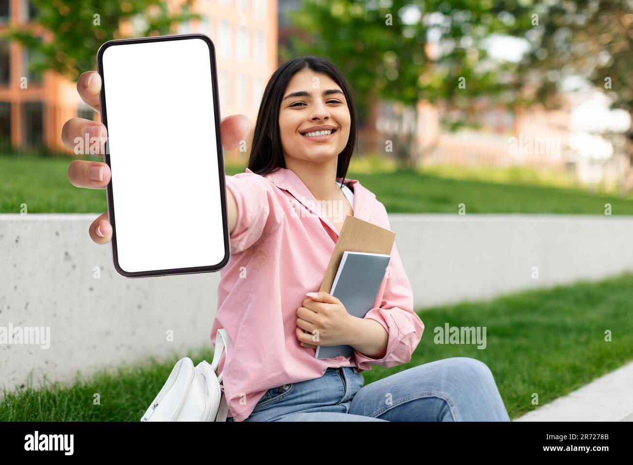 Great educational app. Happy student female showing smartphone with ...