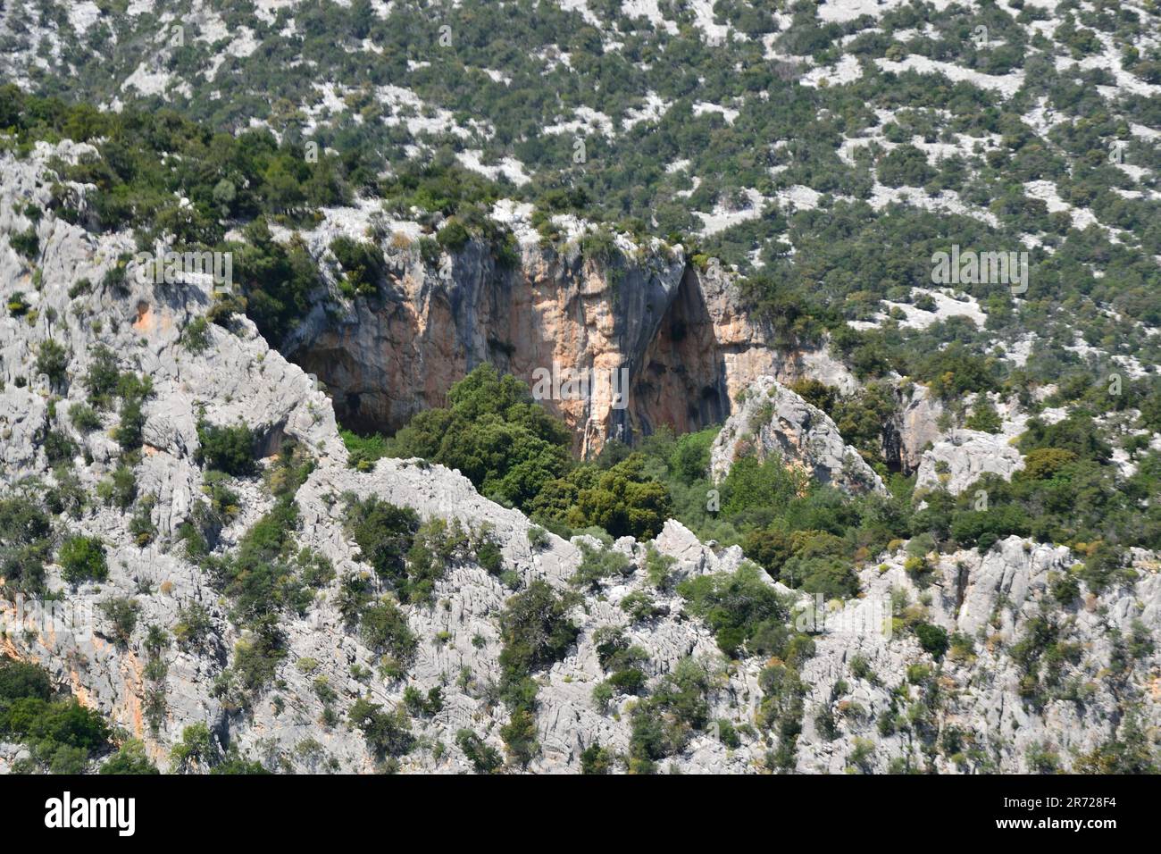 The path to cuile Sas Traes, view of Monte tiscali and its sinkhole ...