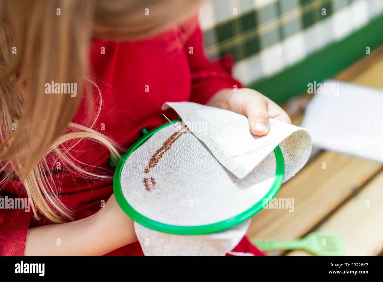 Close-up detail female child hands embroidering round hoop fabric frame ...