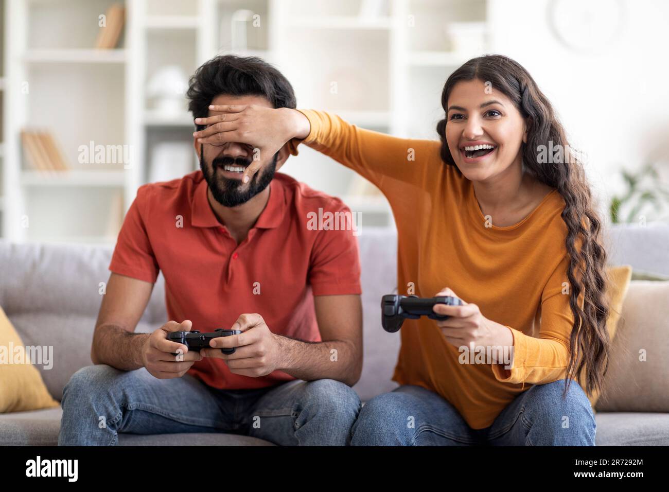 Cheerful Indian Couple Having Fun At Home, Playing Video Games Together ...