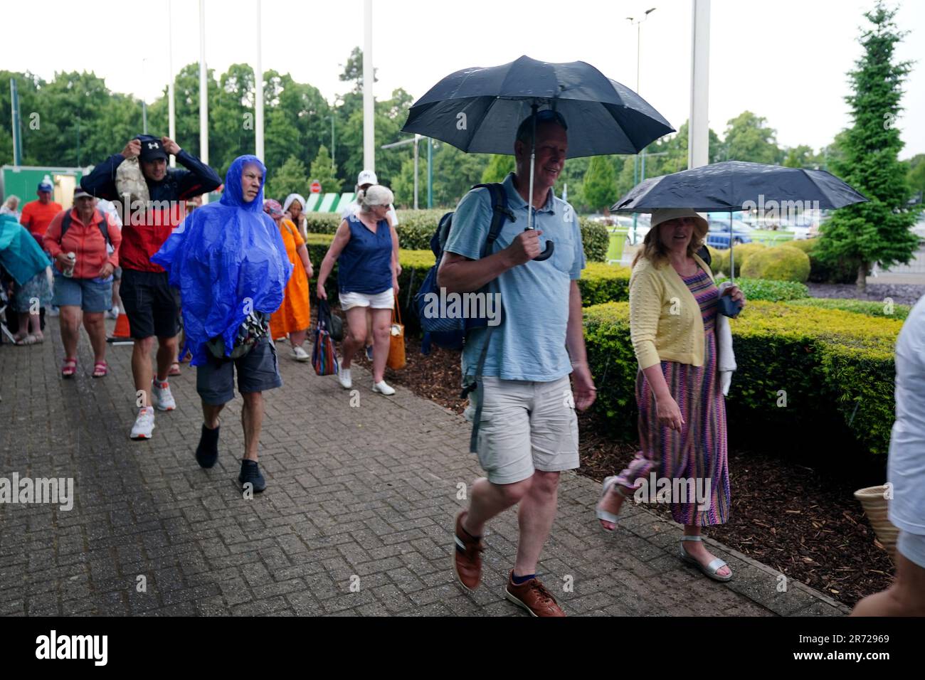 People shelter during a rain and lightning delay during day one of the ...