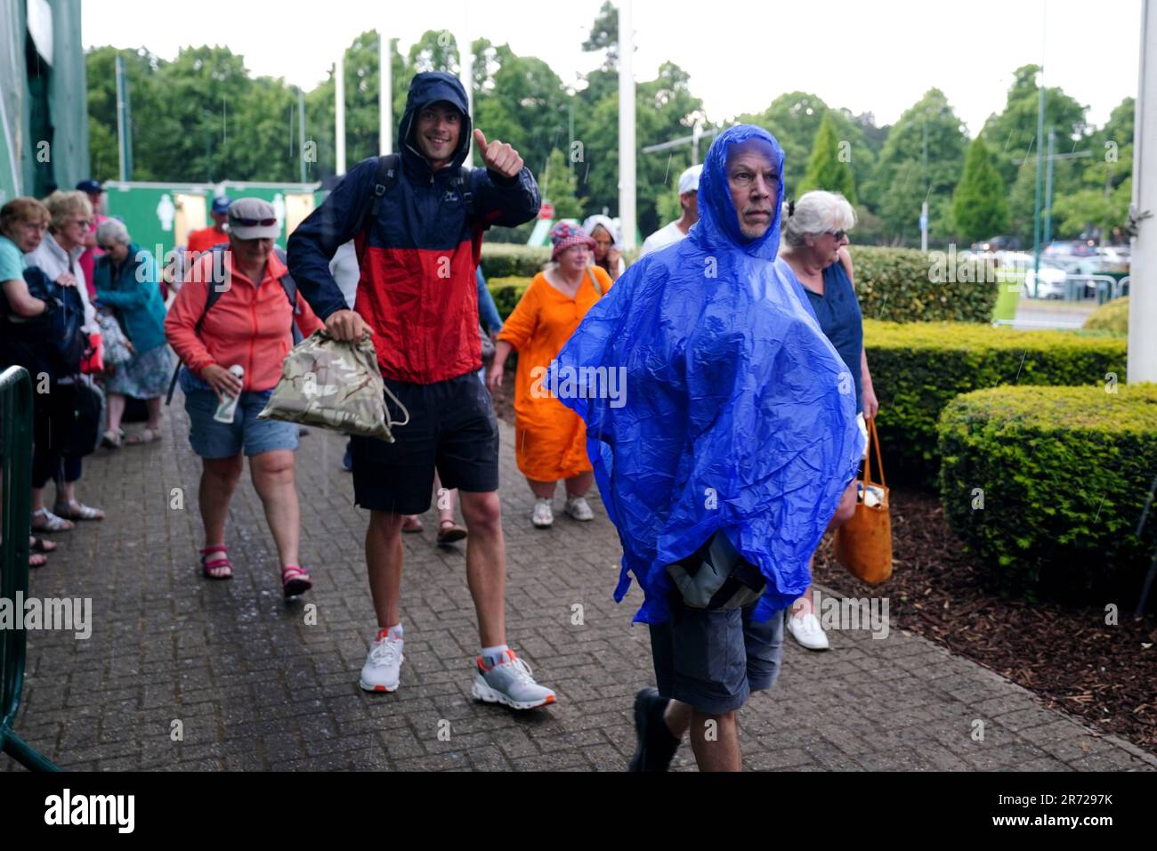People shelter during a rain and lightning delay during day one of the ...