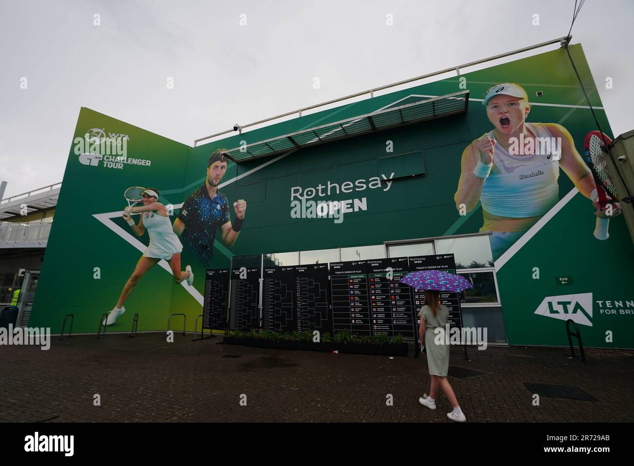 People shelter during a rain and lightning delay during day one of the ...