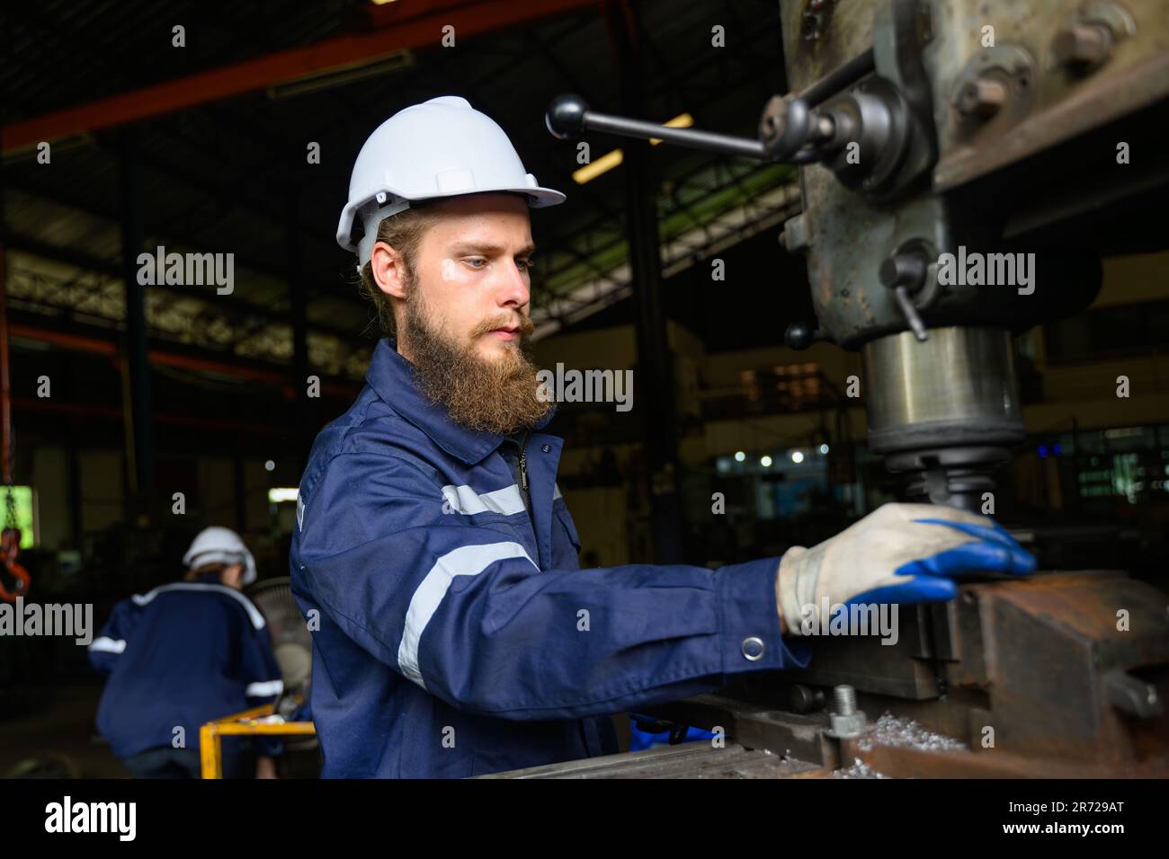Mechanical engineers repairing engine machine at factory Stock Photo ...