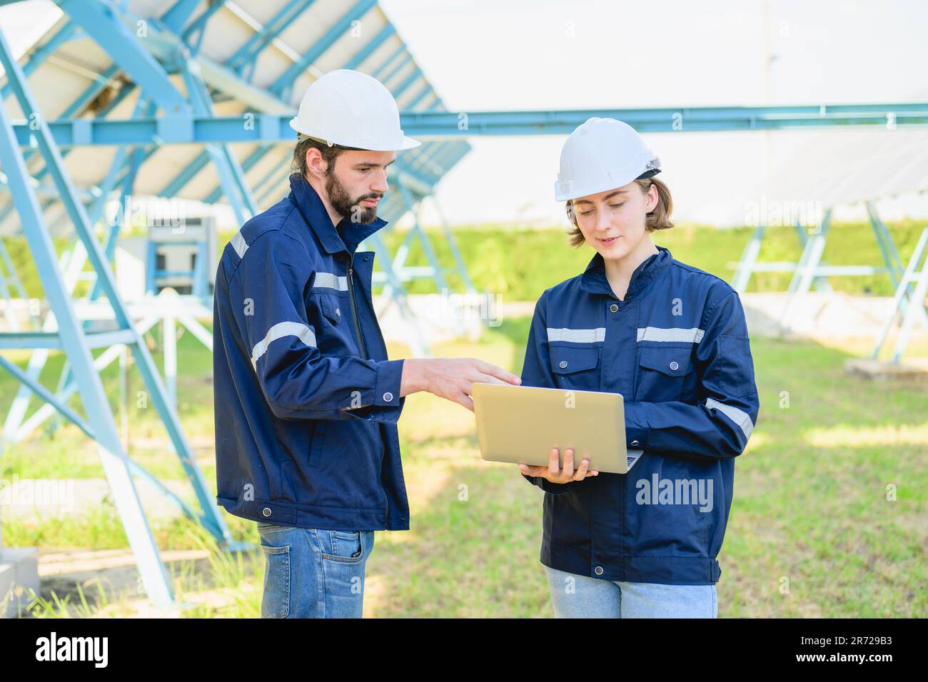 Professional engineers working together at solar power station Stock ...
