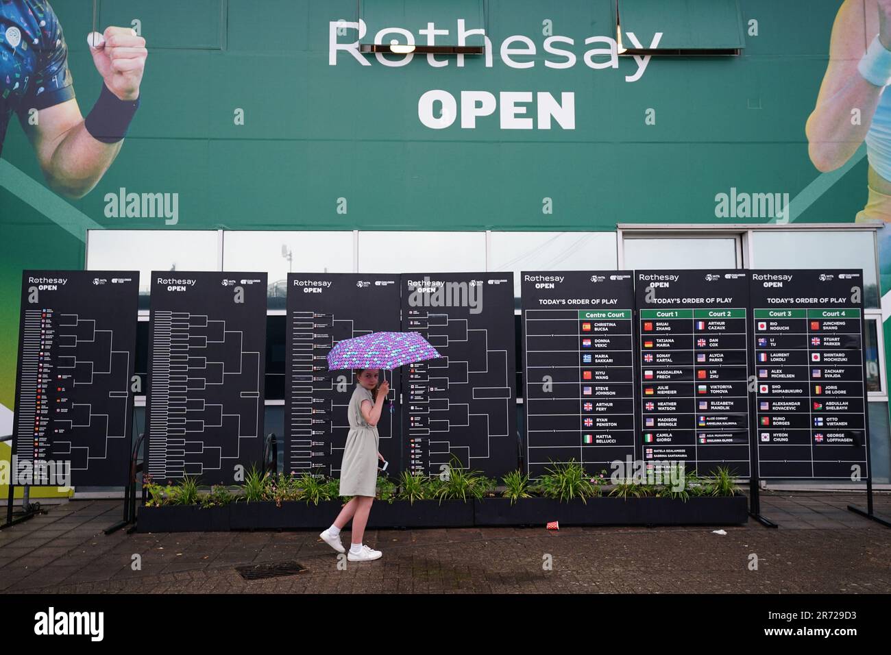 People shelter during a rain and lightning delay during day one of the ...