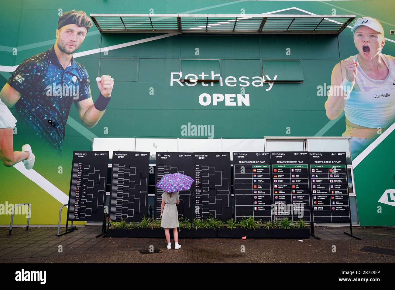 People shelter during a rain and lightning delay during day one of the ...