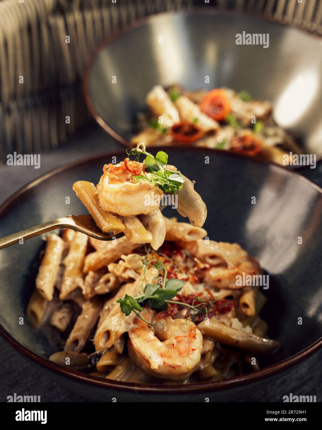 A ceramic bowl with a delicious plate of Shrimp Rigatoni Pasta with ...