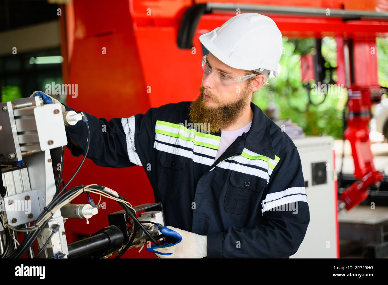 Mechanical engineer repairing engine machine at factory Stock Photo - Alamy