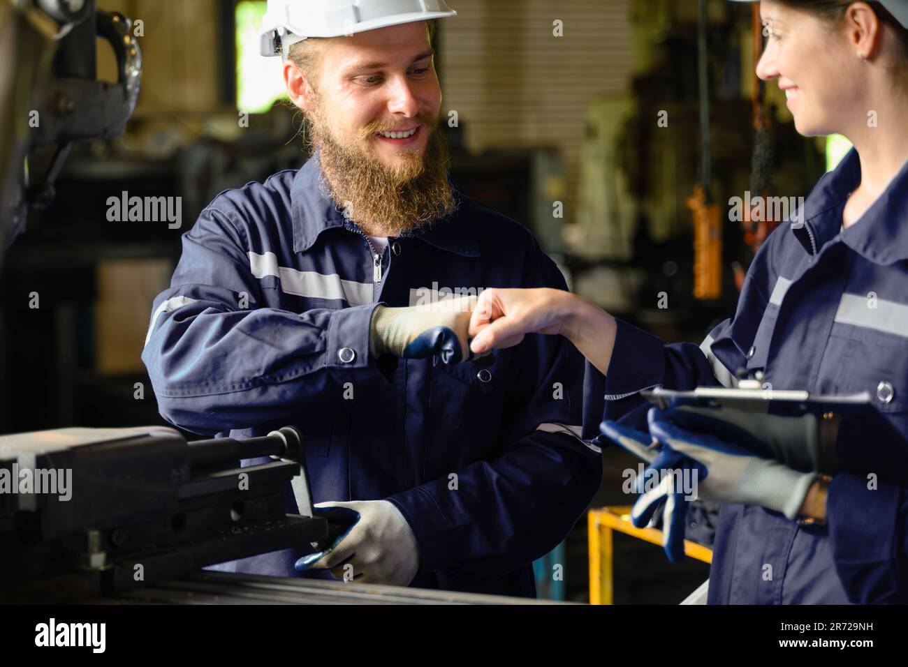 Mechanical engineers repairing engine machine at factory Stock Photo ...
