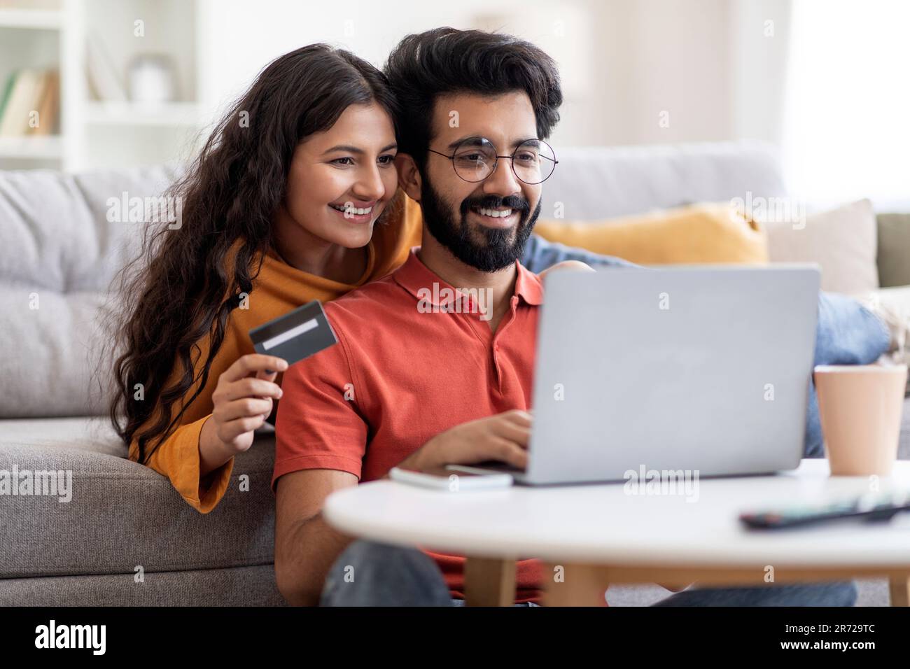Online Auction. Indian Couple With Laptop And Credit Card Making ...