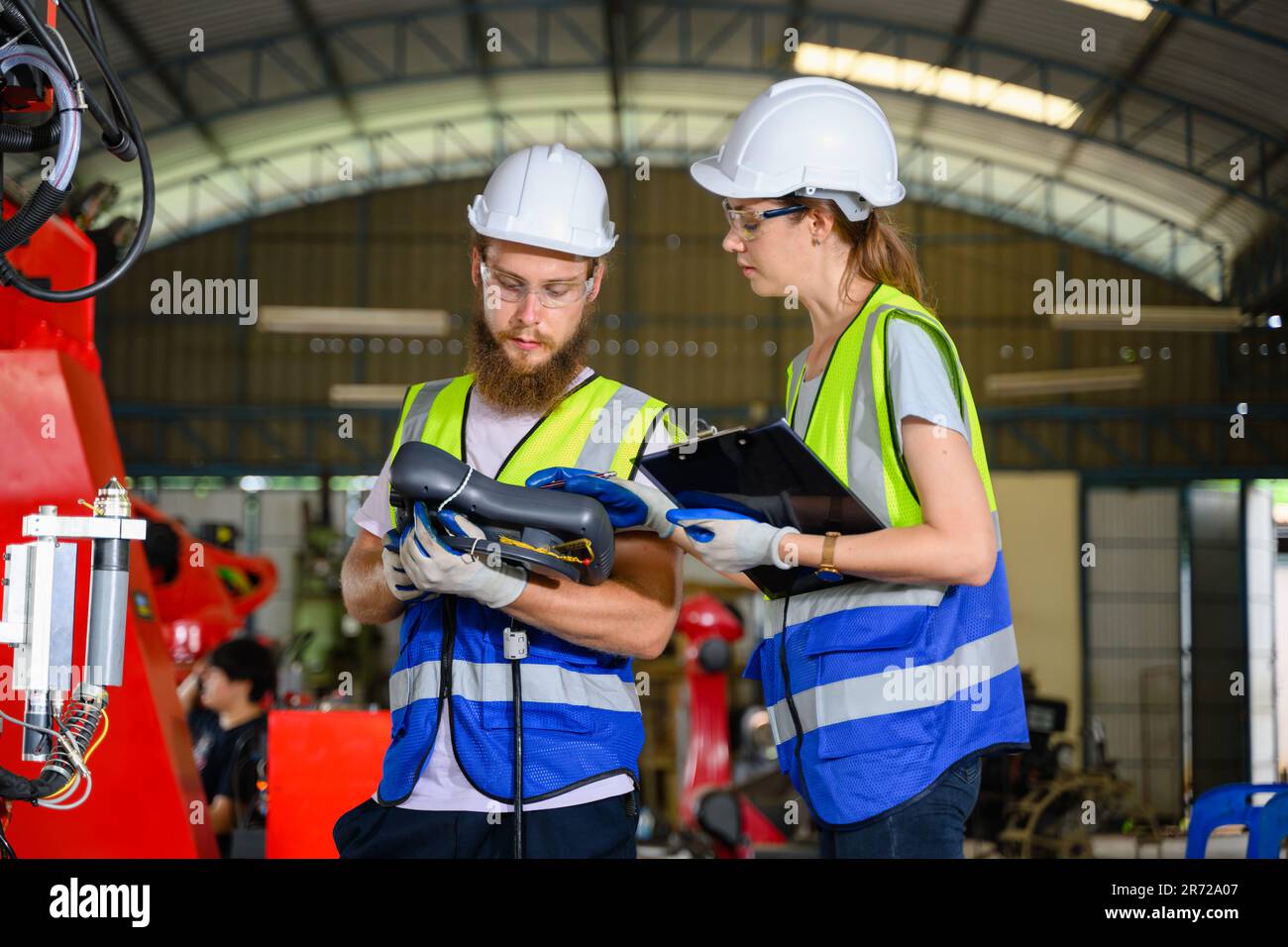 Mechanical engineers repairing engine machine at factory Stock Photo ...