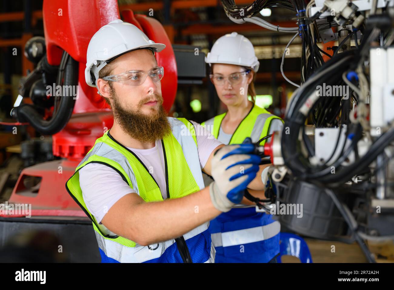 Mechanical engineers repairing engine machine at factory Stock Photo ...